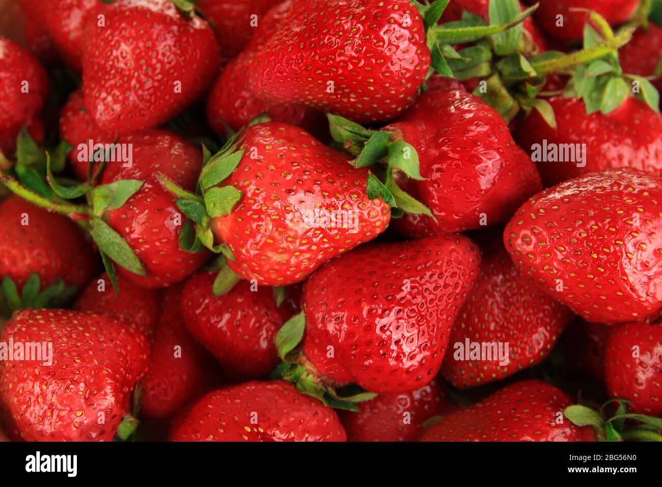 Strawberries in bowl close-up background Stock Photo - Alamy