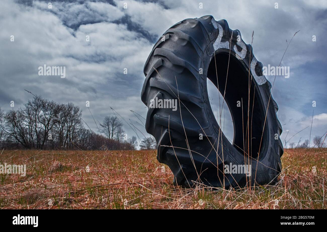 A huge agricultural tractor tire standing in the fields Stock Photo - Alamy