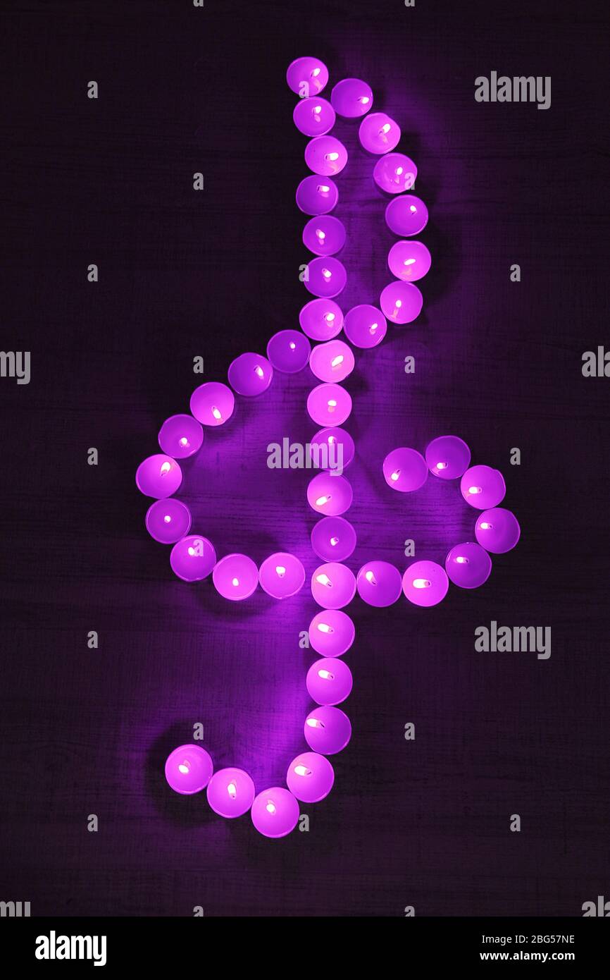 Burning candles as treble clef on dark background Stock Photo - Alamy