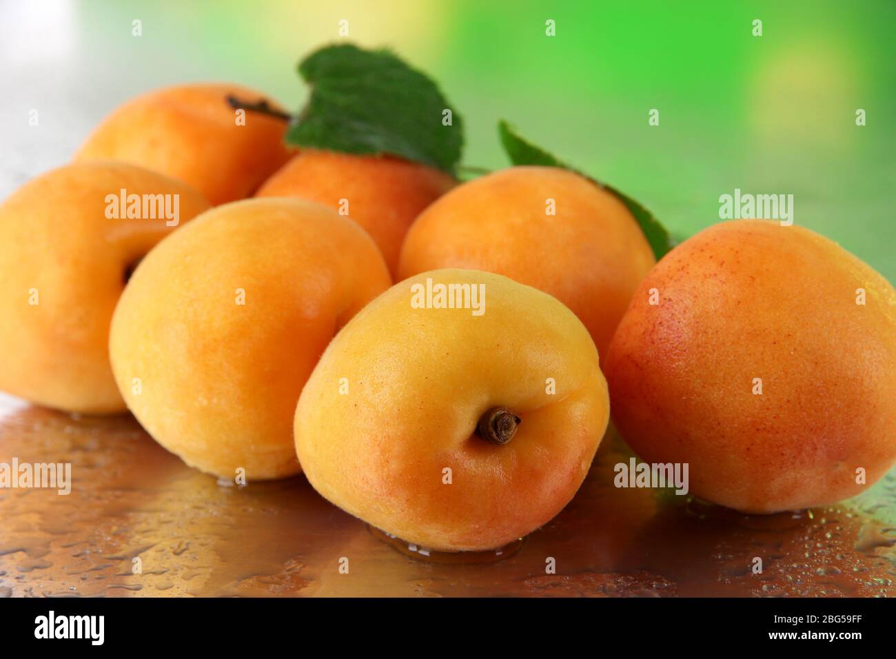 Apricots on nature background Stock Photo - Alamy