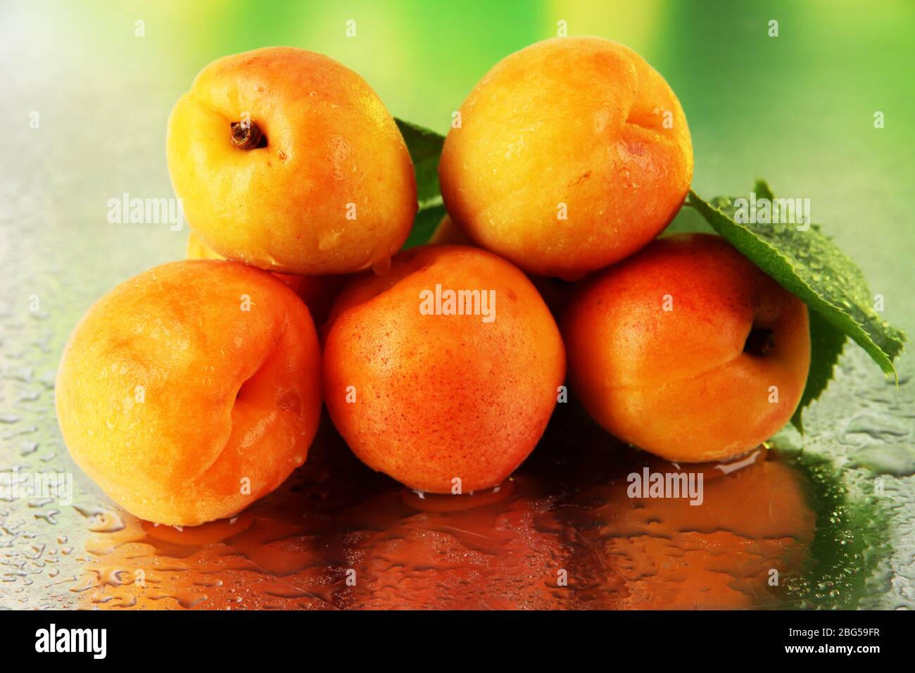 Apricots on nature background Stock Photo - Alamy