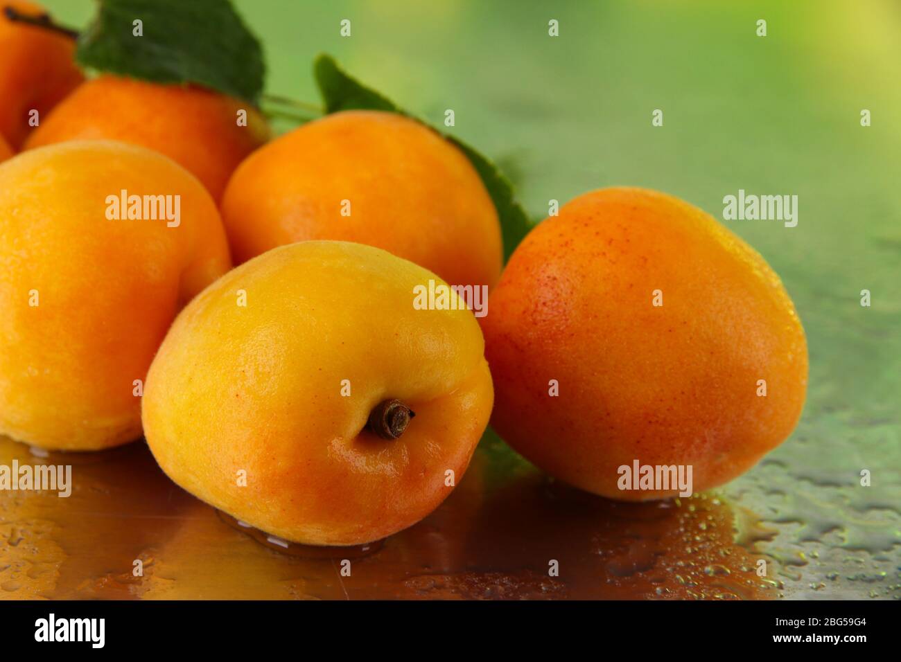 Apricots on nature background Stock Photo - Alamy