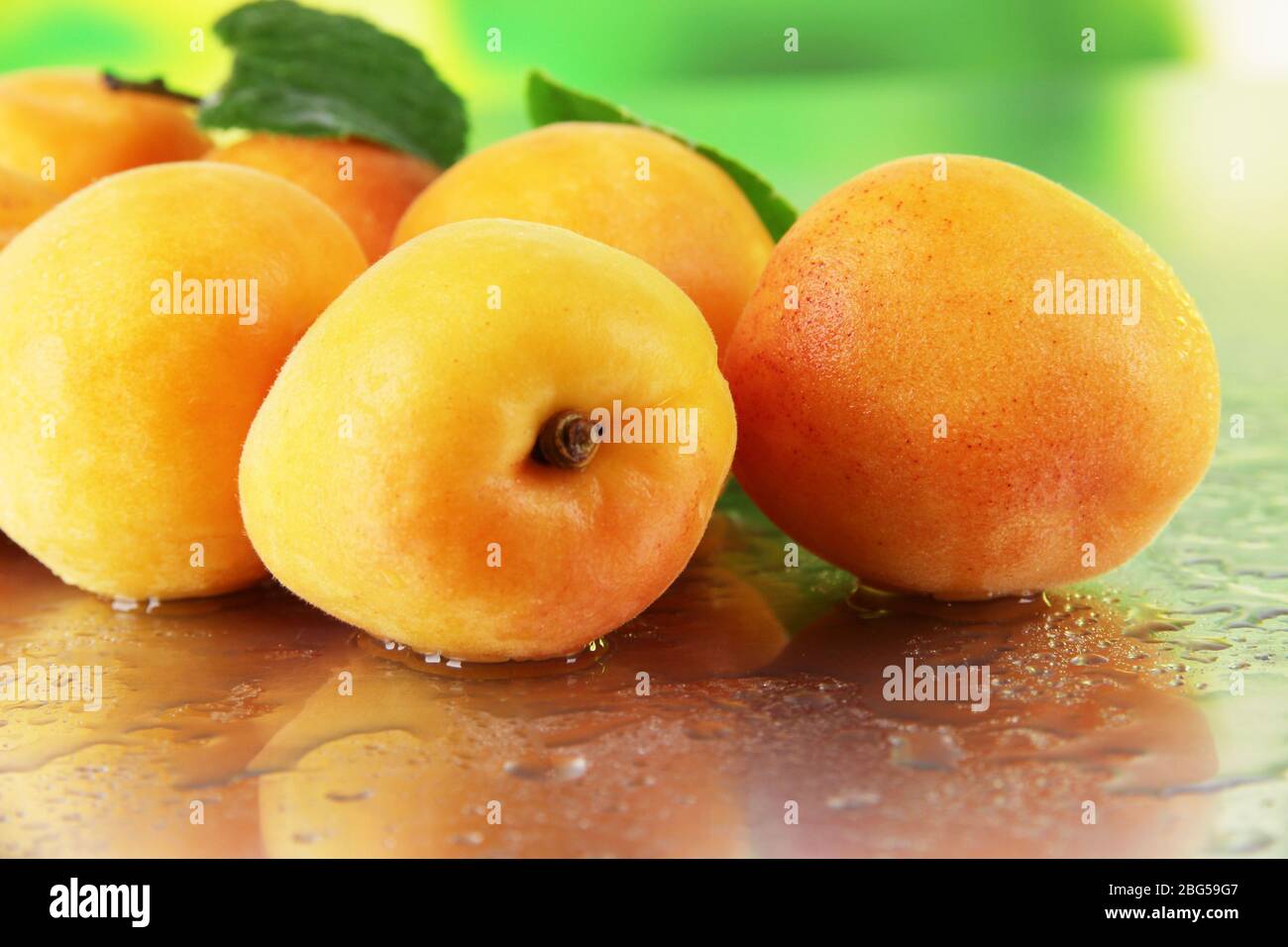 Apricots on nature background Stock Photo - Alamy