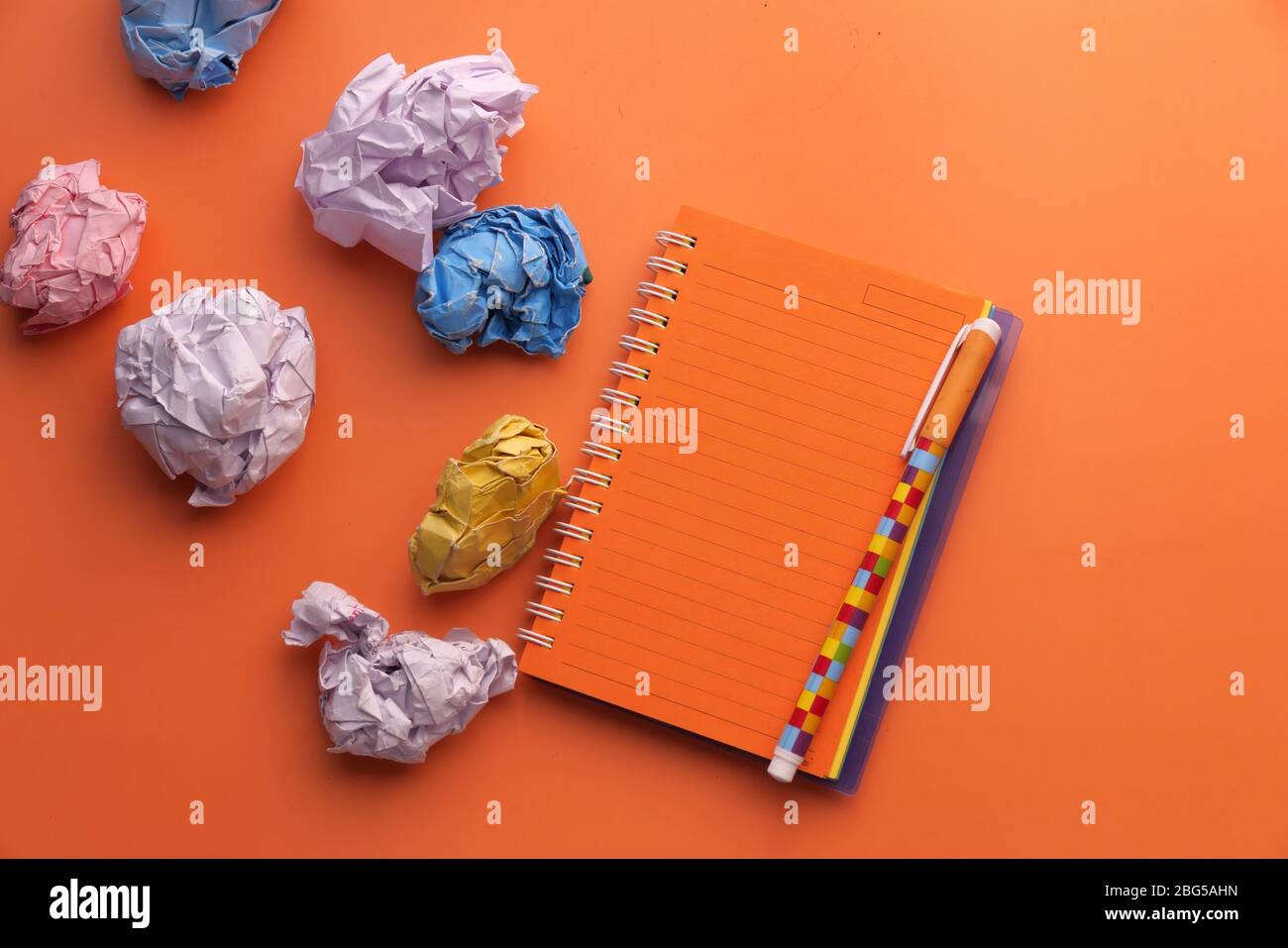 crumpled paper ball and notepad color background Stock Photo - Alamy