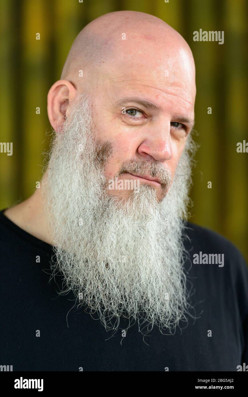Face of mature handsome bald man with long beard outdoors Stock Photo ...
