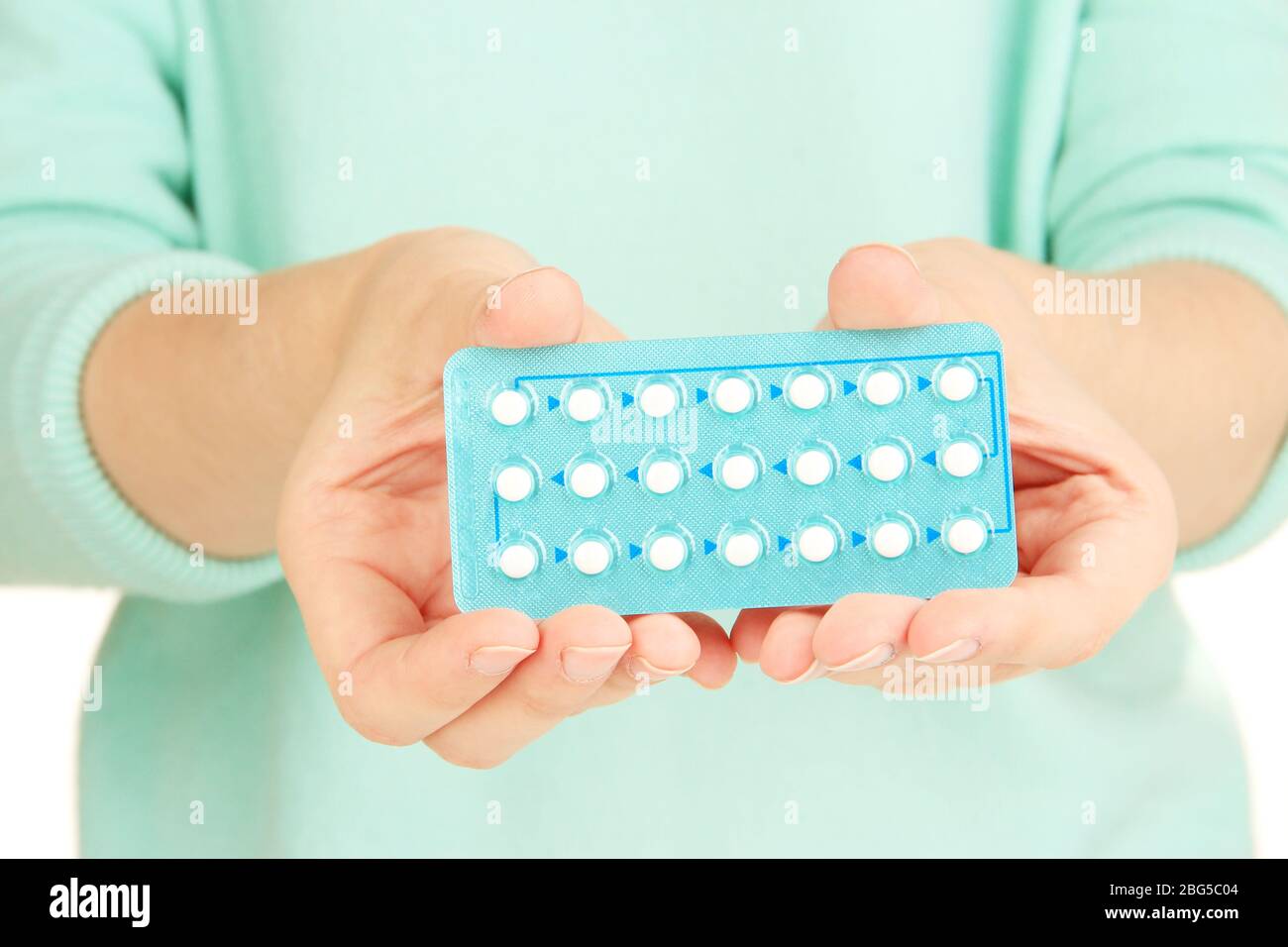 Hormonal pills in female hands isolated on white Stock Photo - Alamy