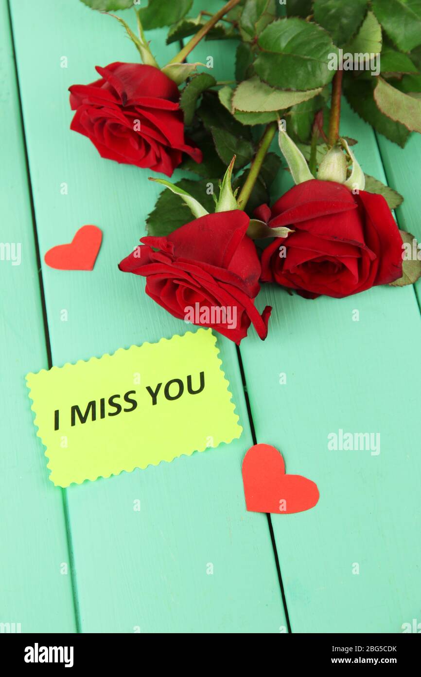 Beautiful roses, on color wooden background Stock Photo - Alamy