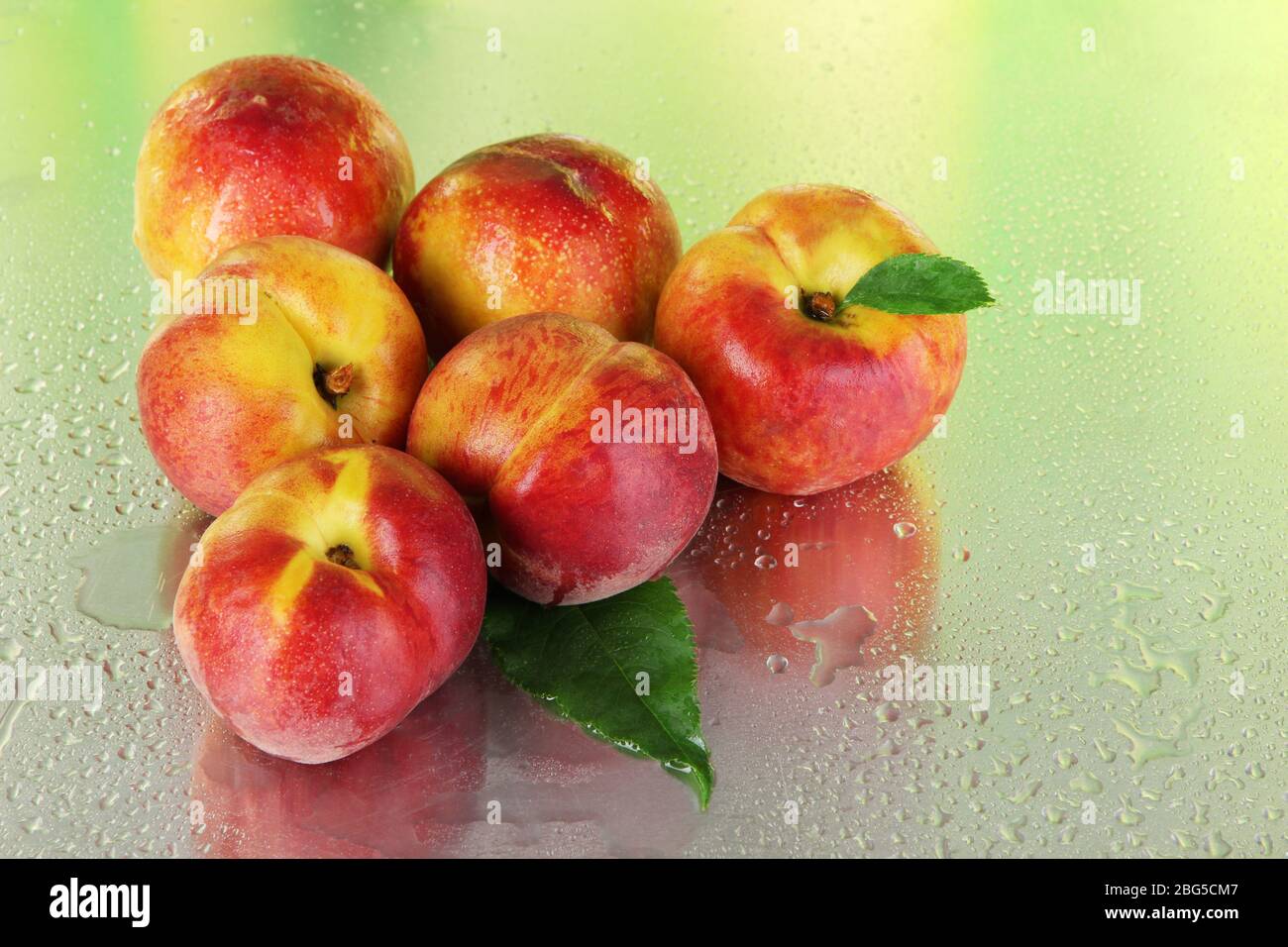 Peaches on metal green background Stock Photo - Alamy