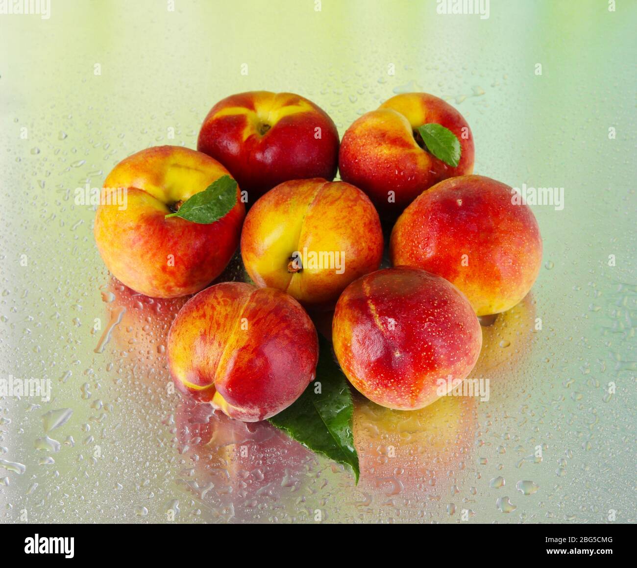 Peaches on metal green background Stock Photo - Alamy