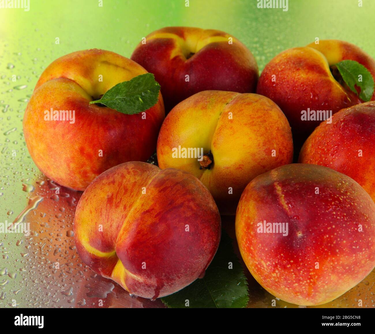 Peaches on metal green background Stock Photo - Alamy