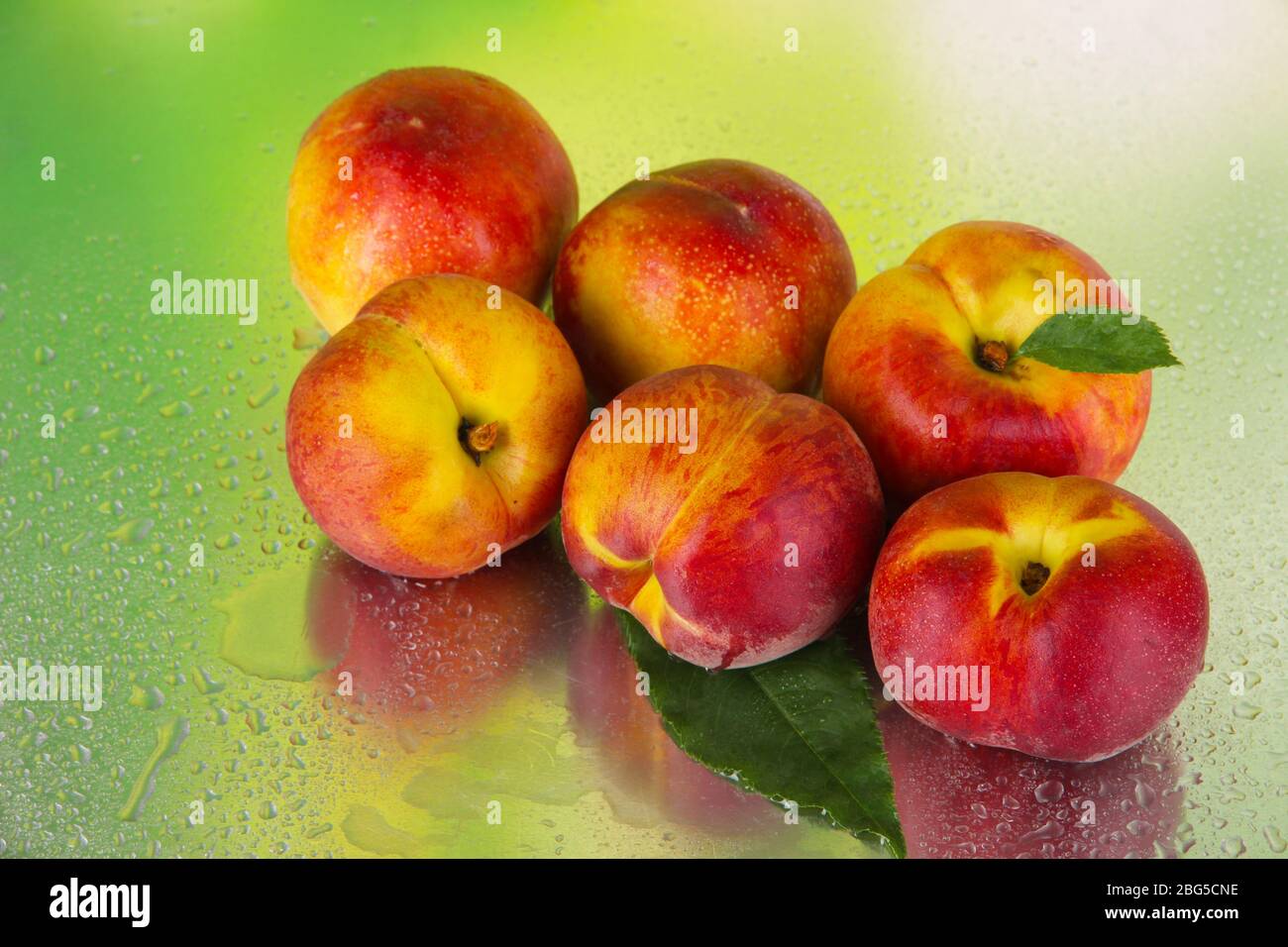Peaches on metal green background Stock Photo - Alamy