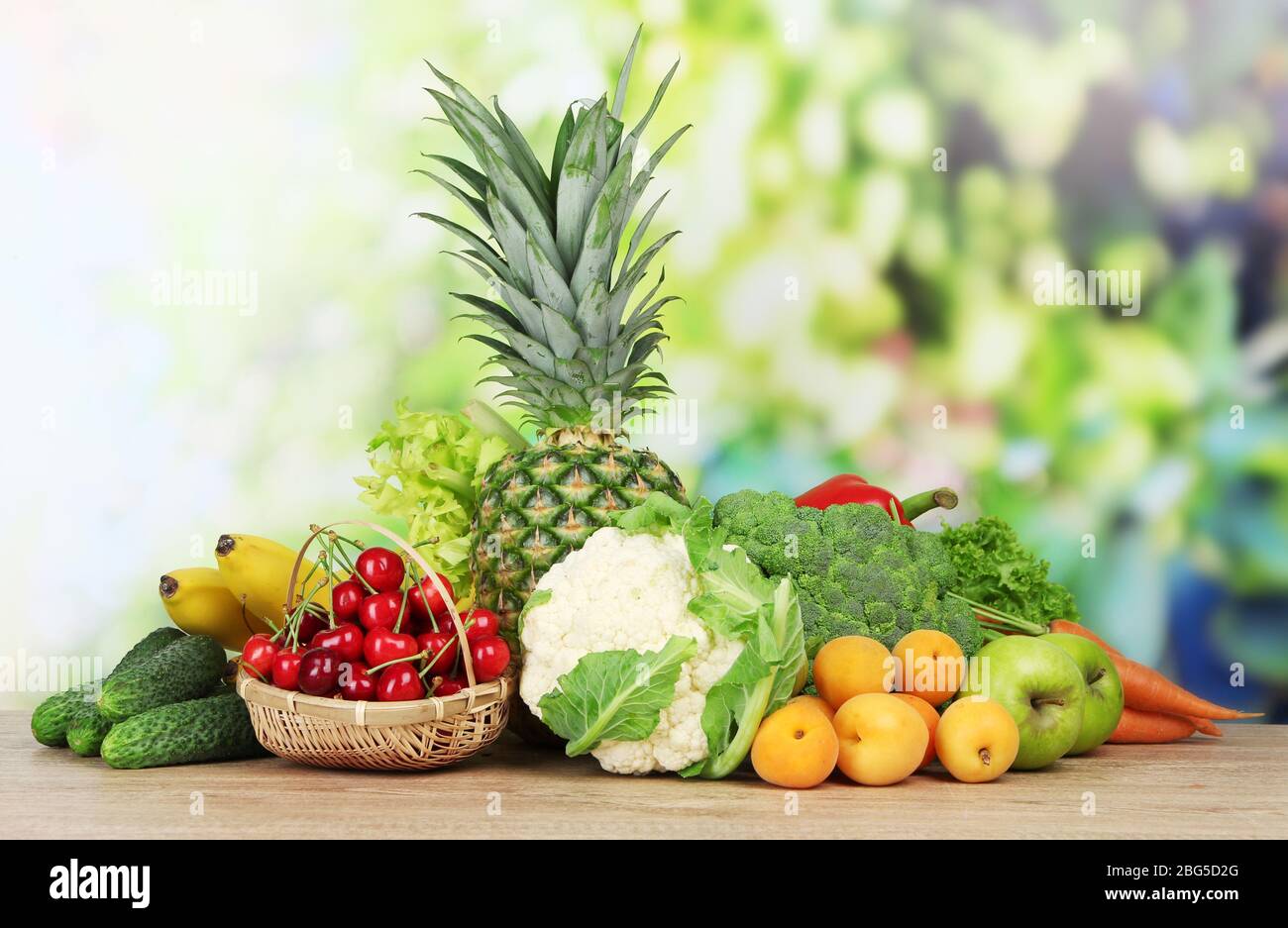 Assortment of fresh fruits and vegetables on natural background Stock ...