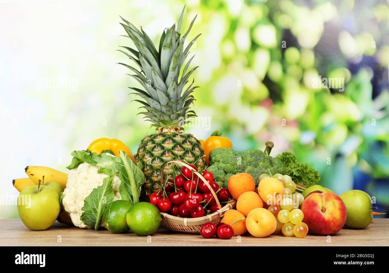 Assortment of fresh fruits and vegetables on natural background Stock ...