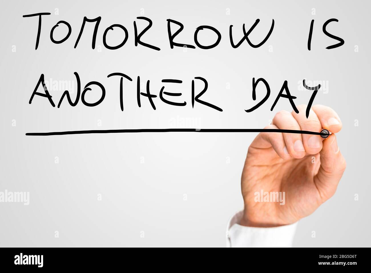 Male hand writing phrase Tomorrow is another day on virtual screen ...