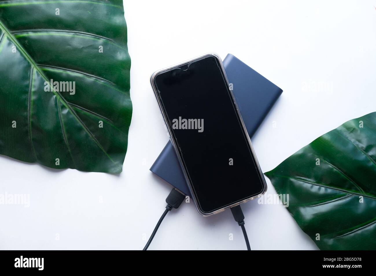 charging smartphone with power bank, high angle view Stock Photo - Alamy