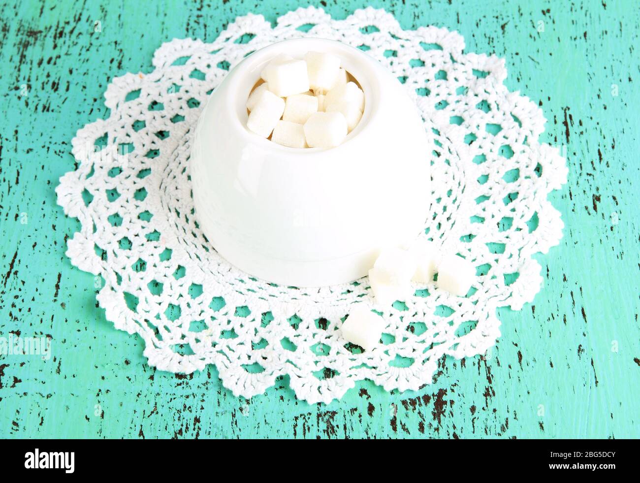 Refined sugar in white sugar bowl on wooden background Stock Photo - Alamy