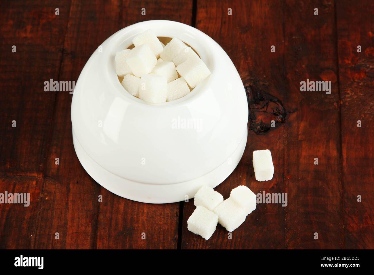 Refined sugar in white sugar bowl on wooden background Stock Photo - Alamy