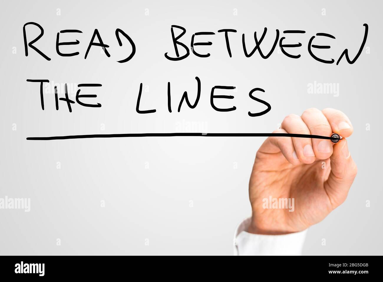 Male hand writing phrase Read between the lines on virtual screen Stock ...