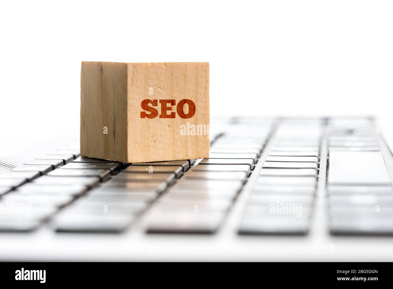 SEO concept with the word written on a wooden block lying on a computer ...
