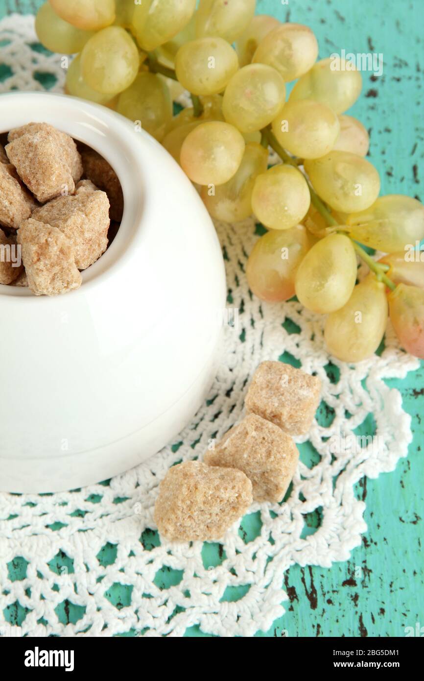 Unrefined sugar in white sugar bowl on wooden background Stock Photo ...
