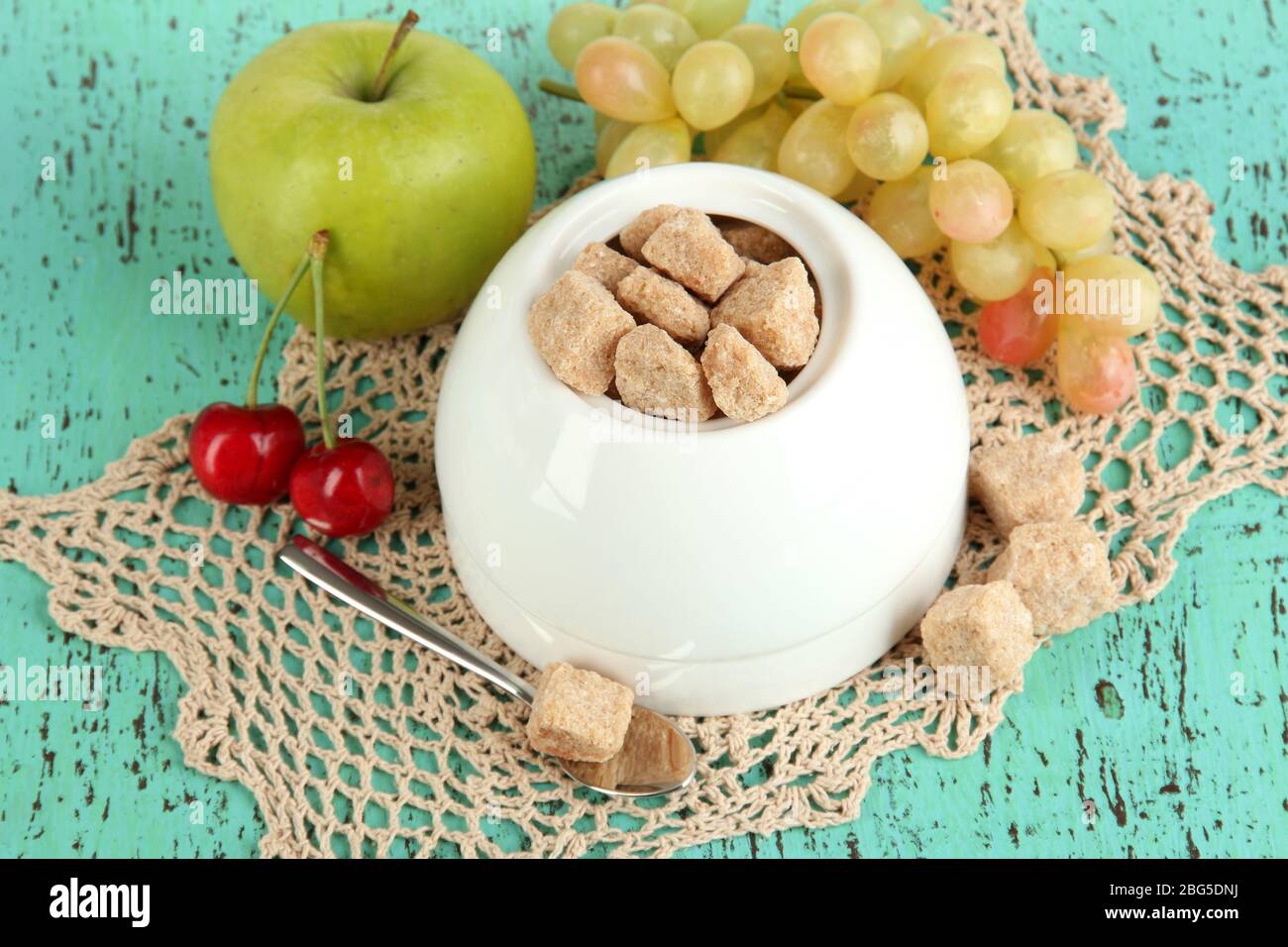 Unrefined sugar in white sugar bowl on wooden background Stock Photo ...