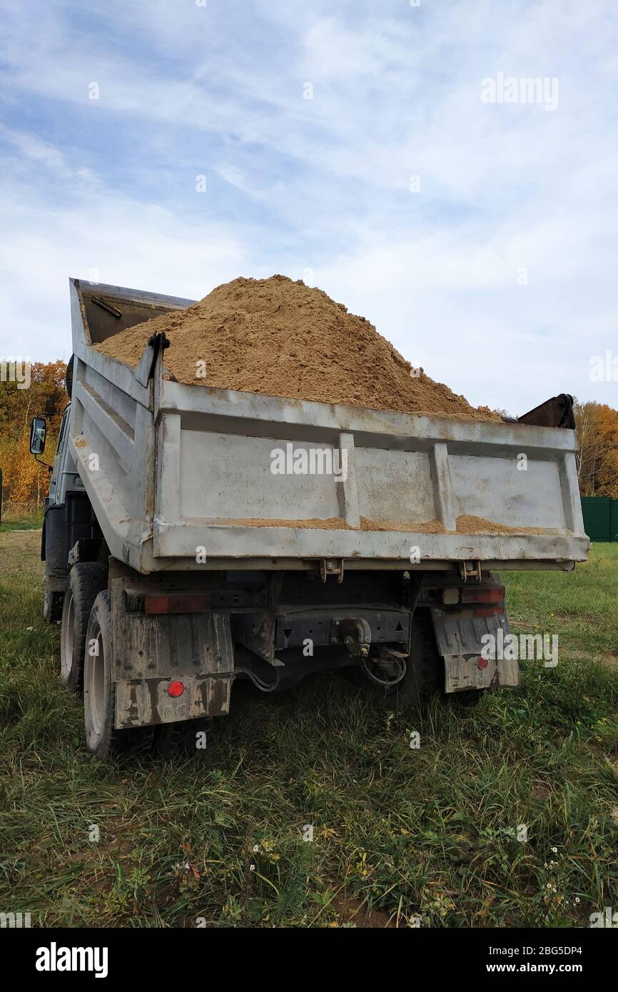 A dump truck unloads sand in the construction site.2020 Stock Photo - Alamy