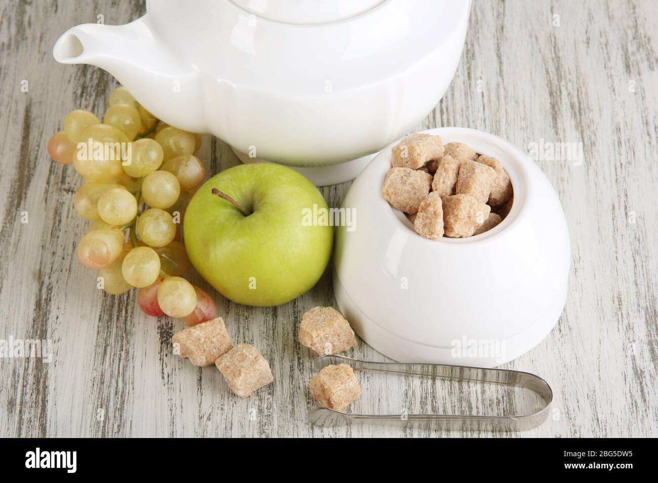 Unrefined sugar in white sugar bowl on wooden background Stock Photo ...