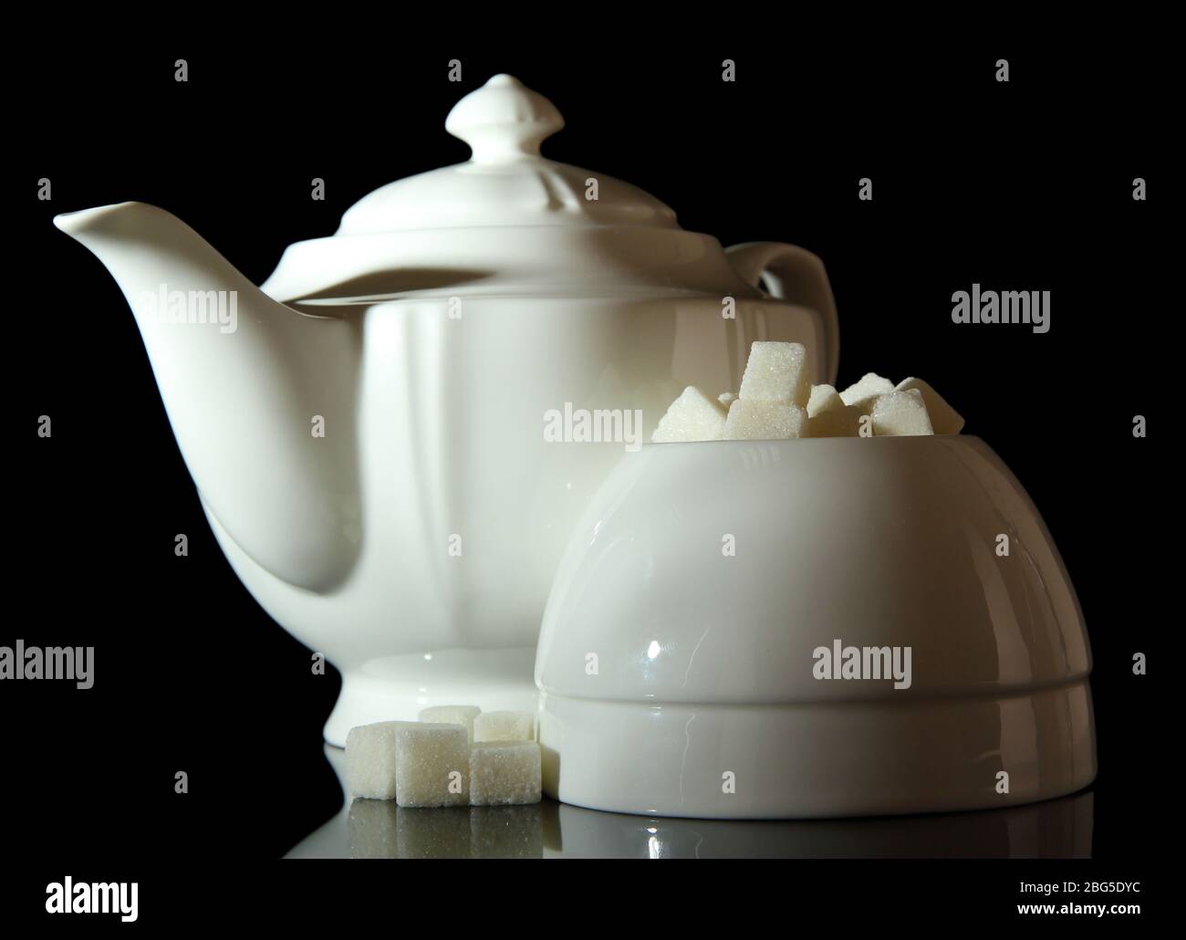 Refined sugar in white sugar bowl on black background Stock Photo - Alamy
