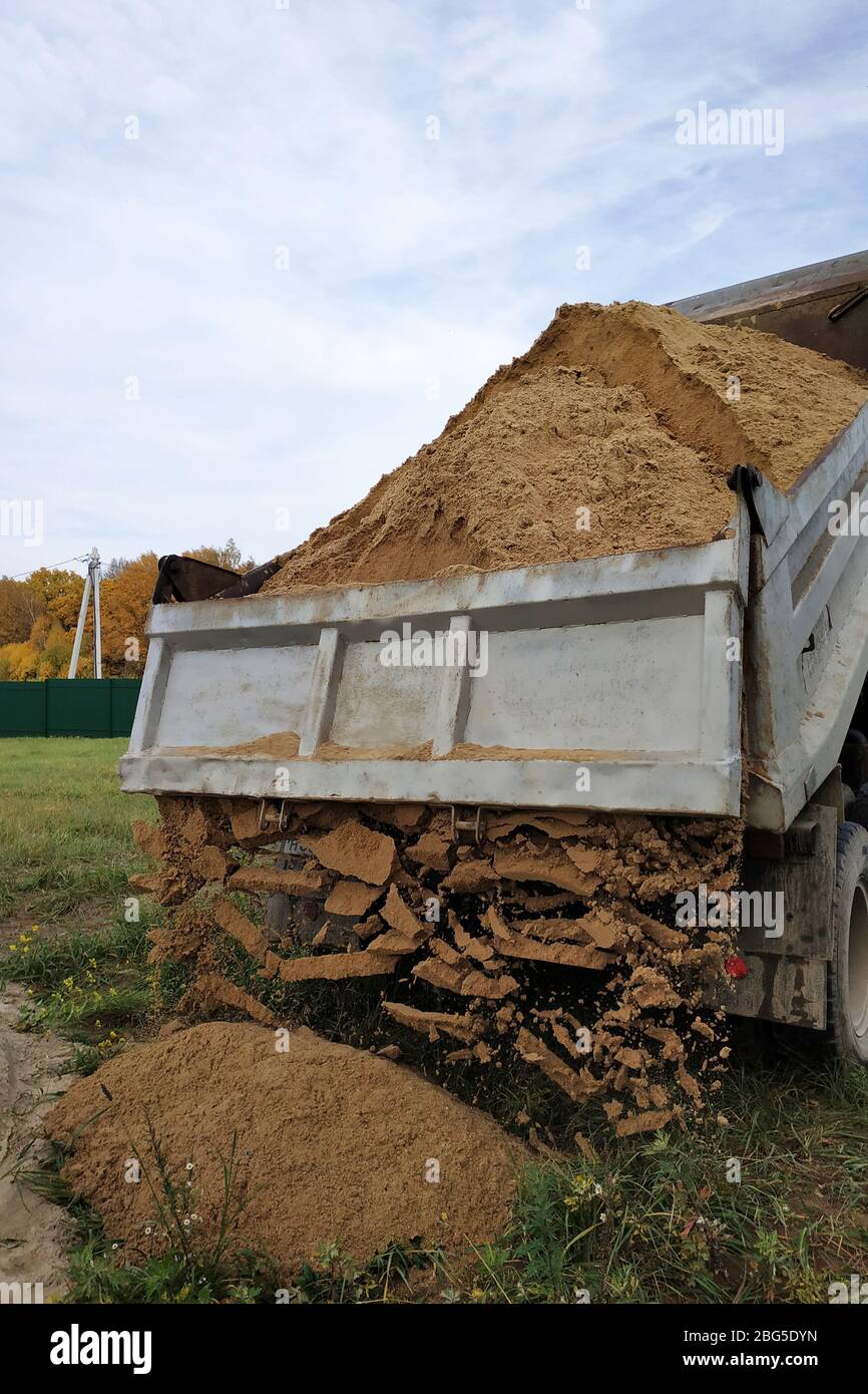 A dump truck unloads sand in the construction site.2020 Stock Photo - Alamy