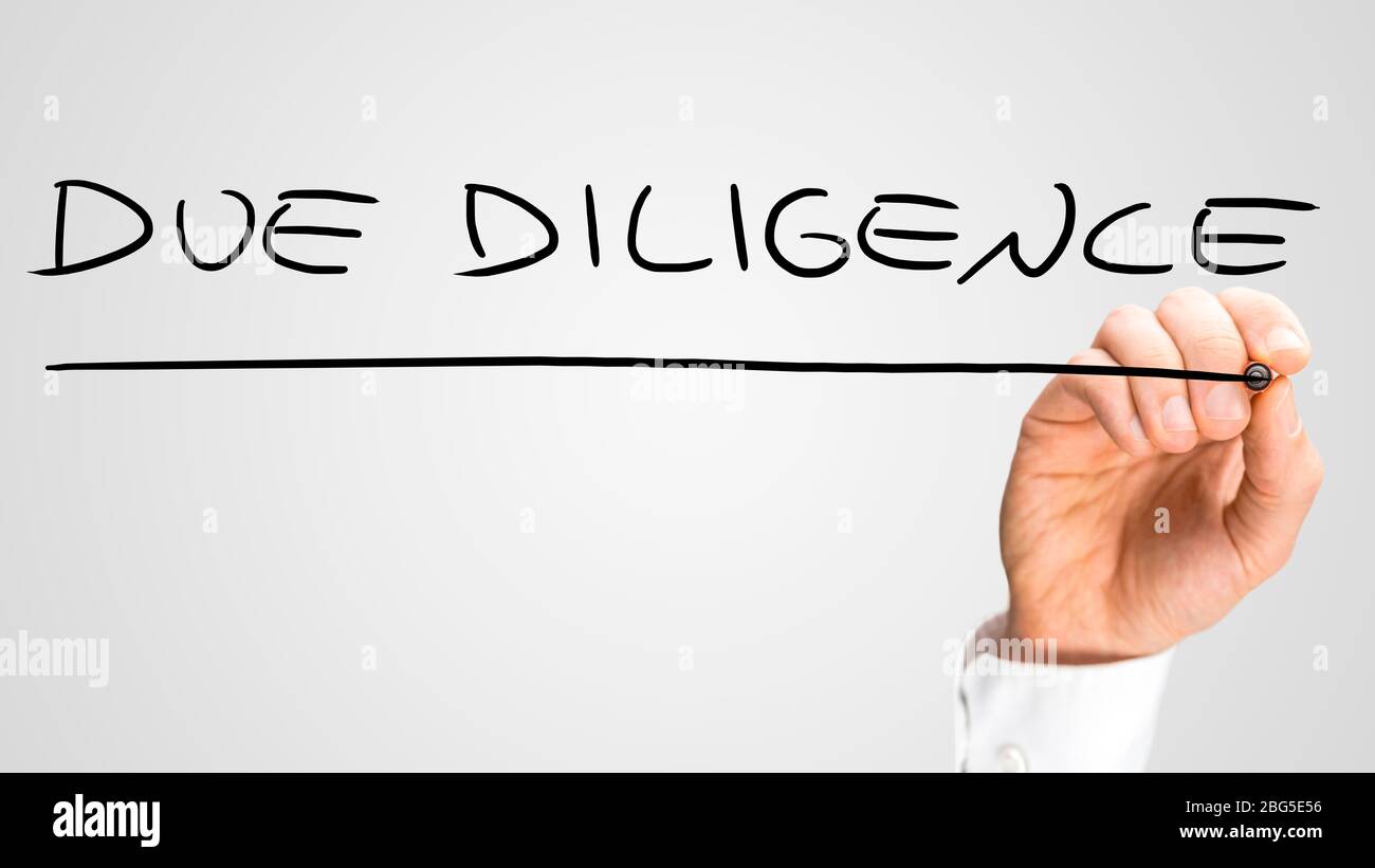 Man writing Due Diligence on a virtual interface conceptual of ... Man writing Due Diligence on a virtual interface conceptual of ...