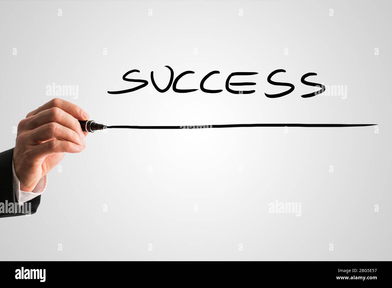 Man writing the word - SUCCESS - with a black marker pen from behind a ...