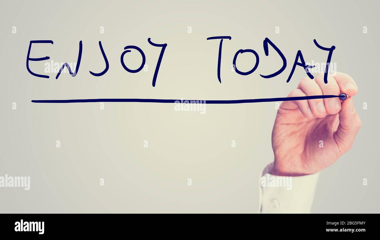 Retro instagram style image of a male hand writing Enjoy today on ...