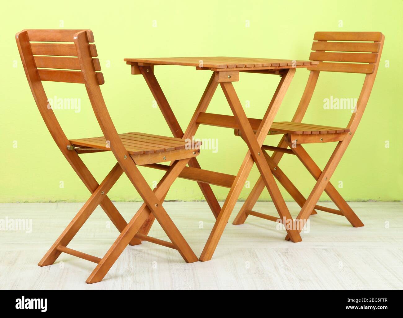 Wooden table with chairs in room Stock Photo - Alamy