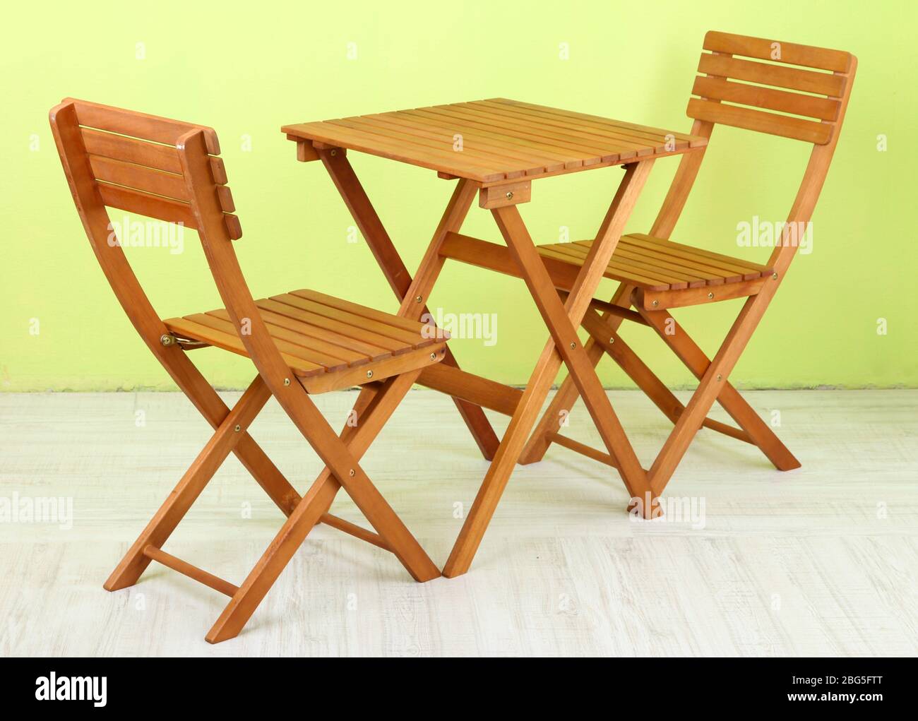 Wooden table with chairs in room Stock Photo - Alamy