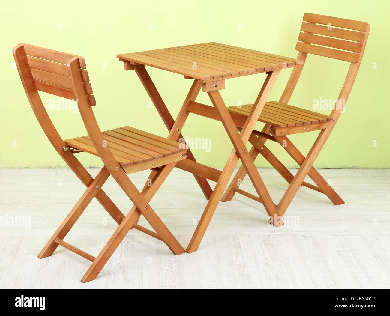 Wooden table with chairs in room Stock Photo - Alamy
