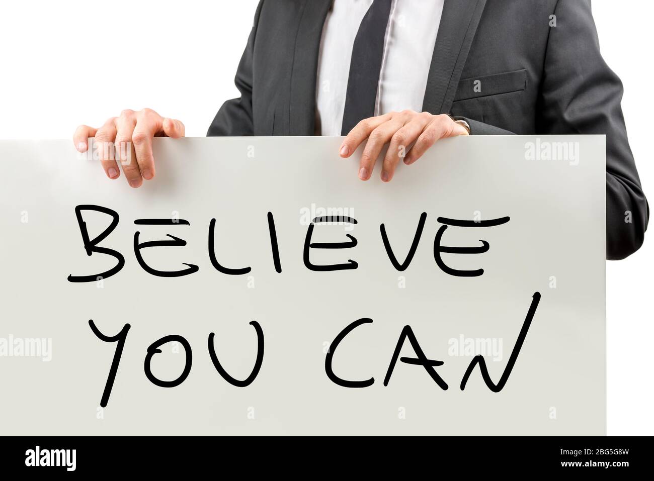 Personal motivator holding white board with Believe you can sign on it ...