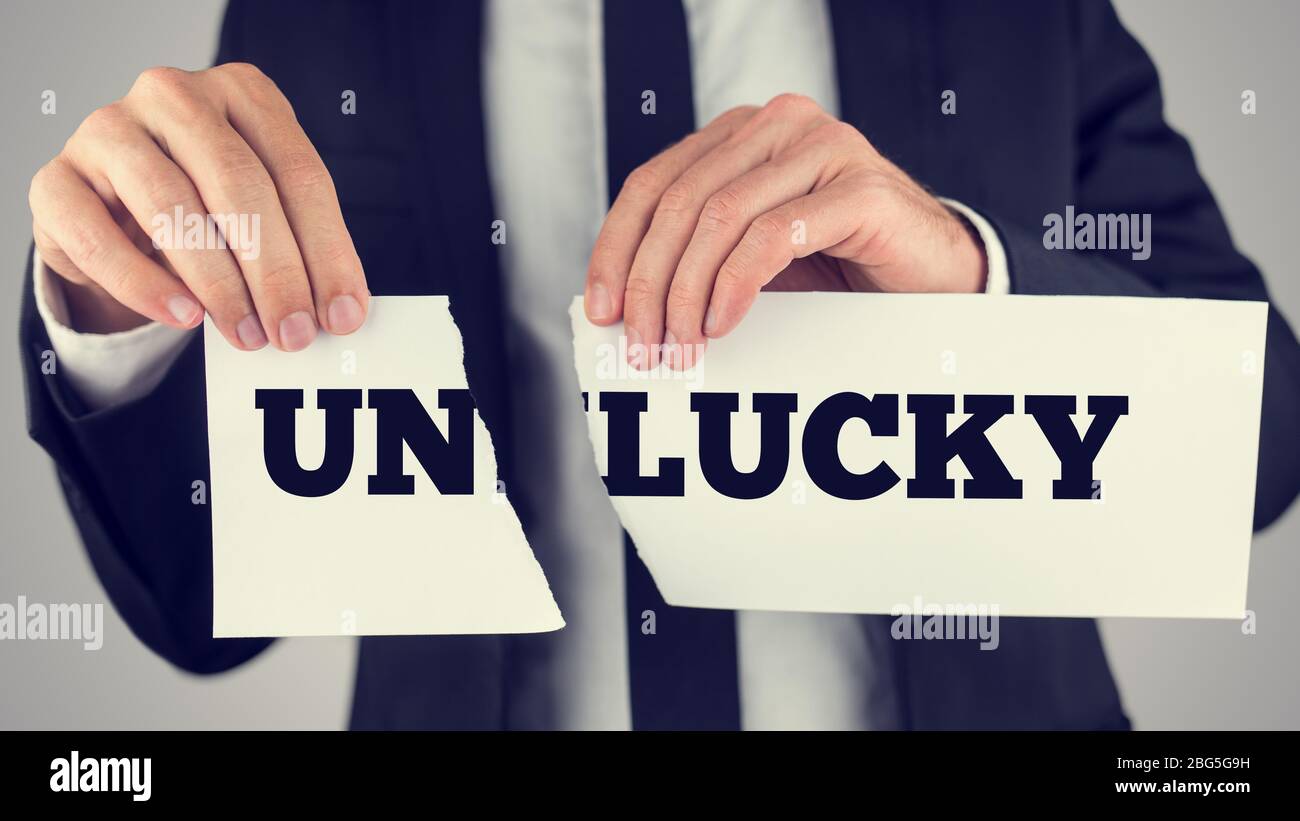 Conceptual Businessman Tearing a Small White Paper with Unlucky Word ...