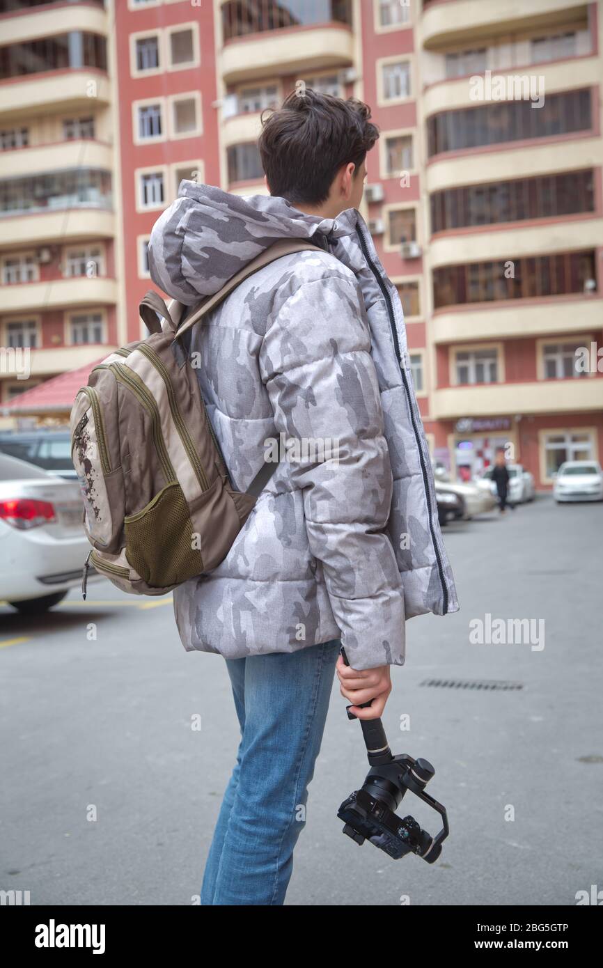 An unidentified man holding gimbal a camera stabilizer . Man holding ...