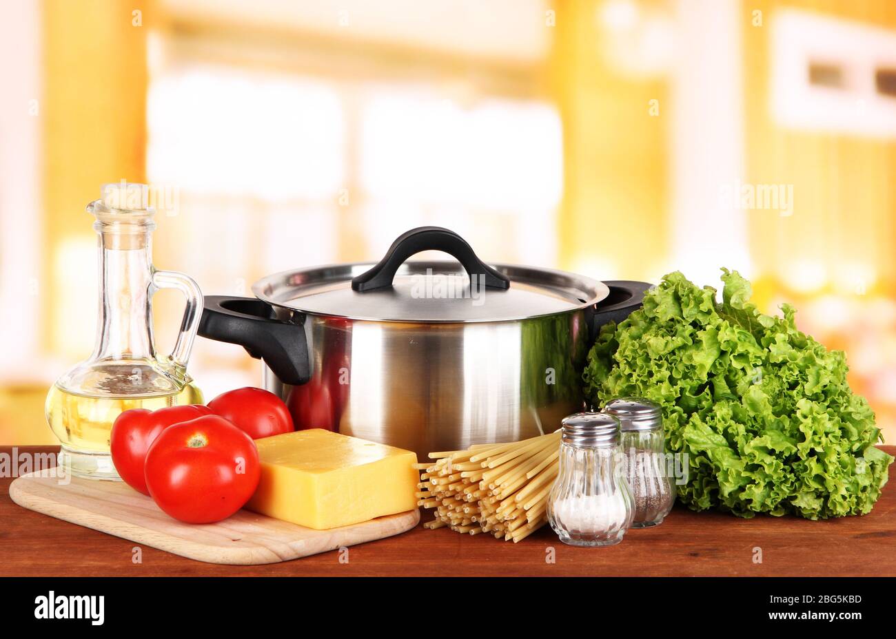 Ingredients for cooking pasta on table in kitchen Stock Photo - Alamy