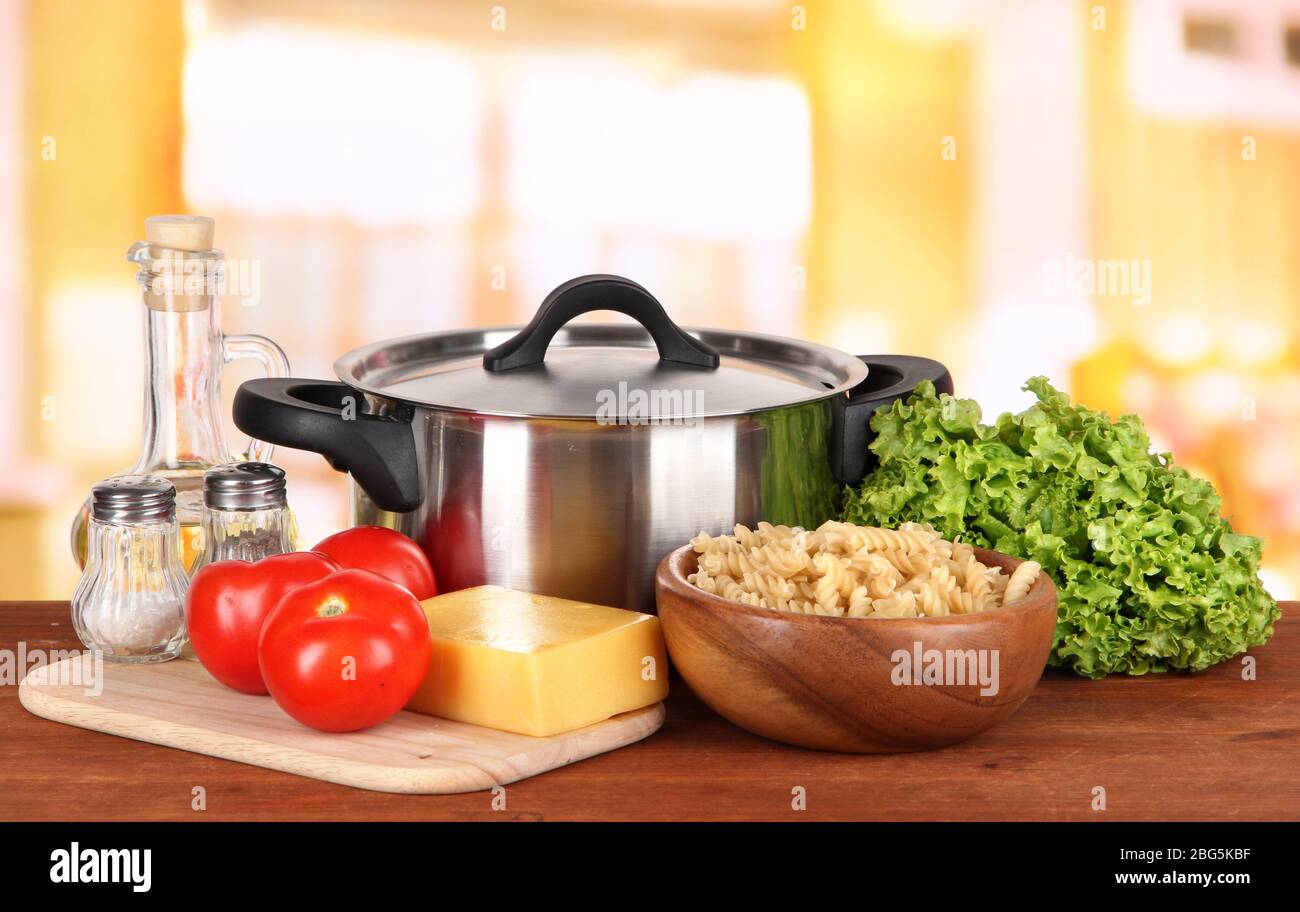 Ingredients for cooking pasta on table in kitchen Stock Photo - Alamy