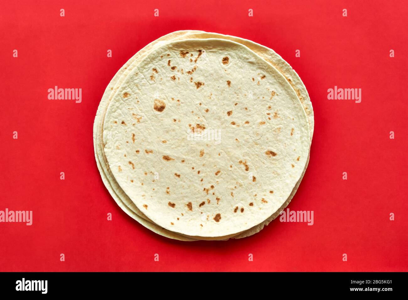 Tortillas on red background. A pile of baked blank corn tortilla wraps ...