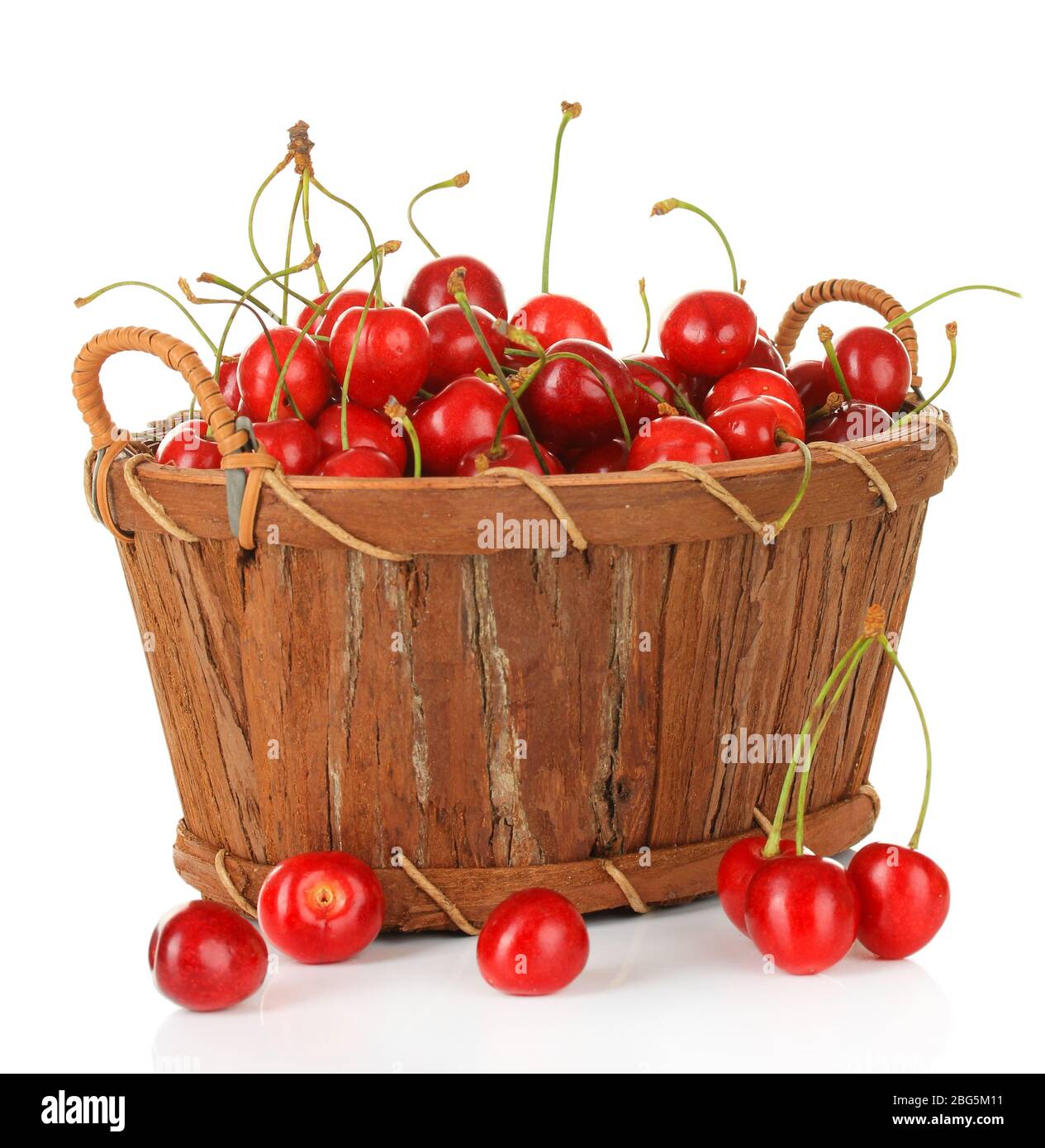 Cherry berries in basket isolated on white Stock Photo - Alamy