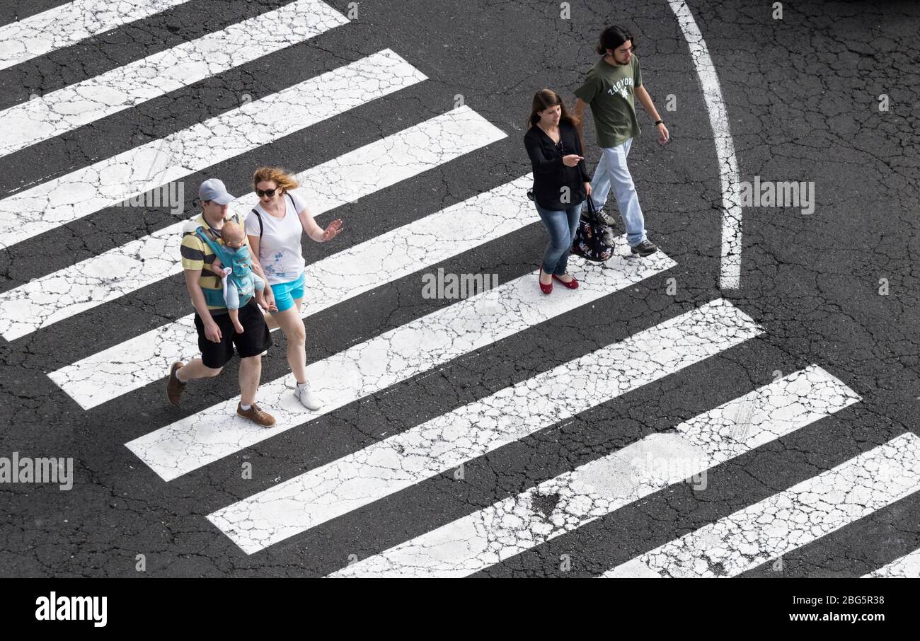 People walking across pedestrian crossing Stock Photo - Alamy