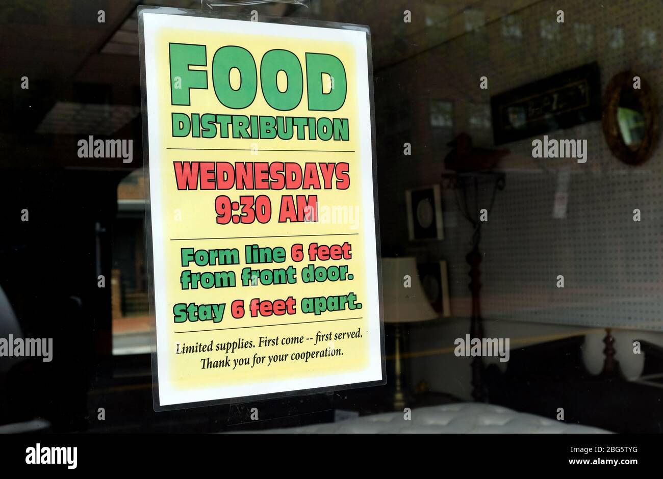 Food Distribution sign in the window of a thrift store during the COVID ...