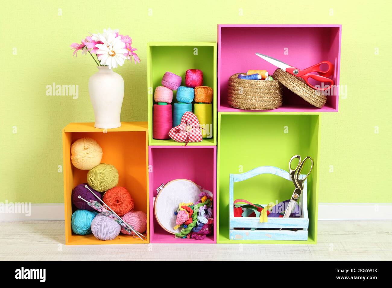 Colorful shelves of different colors with utensils on wall background ...
