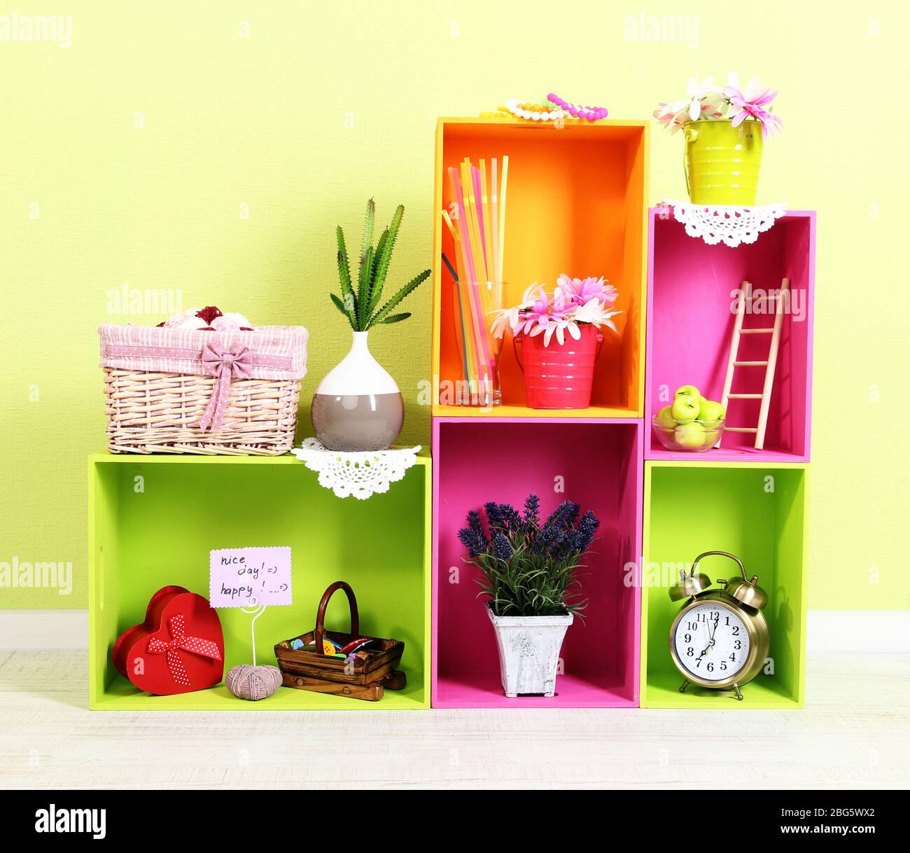 Shelves of different bright colors with decorative addition on wall ...