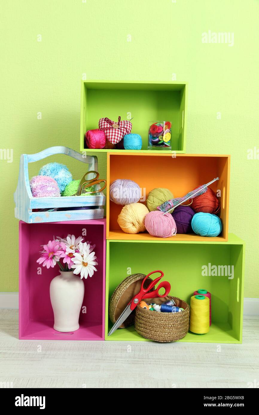 Colorful shelves of different colors with utensils on wall background ...