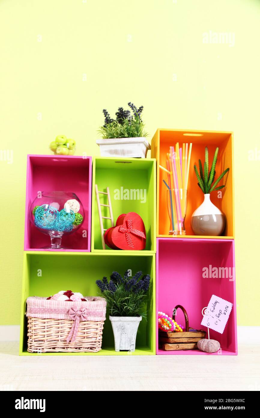 Shelves of different bright colors with decorative addition on wall ...