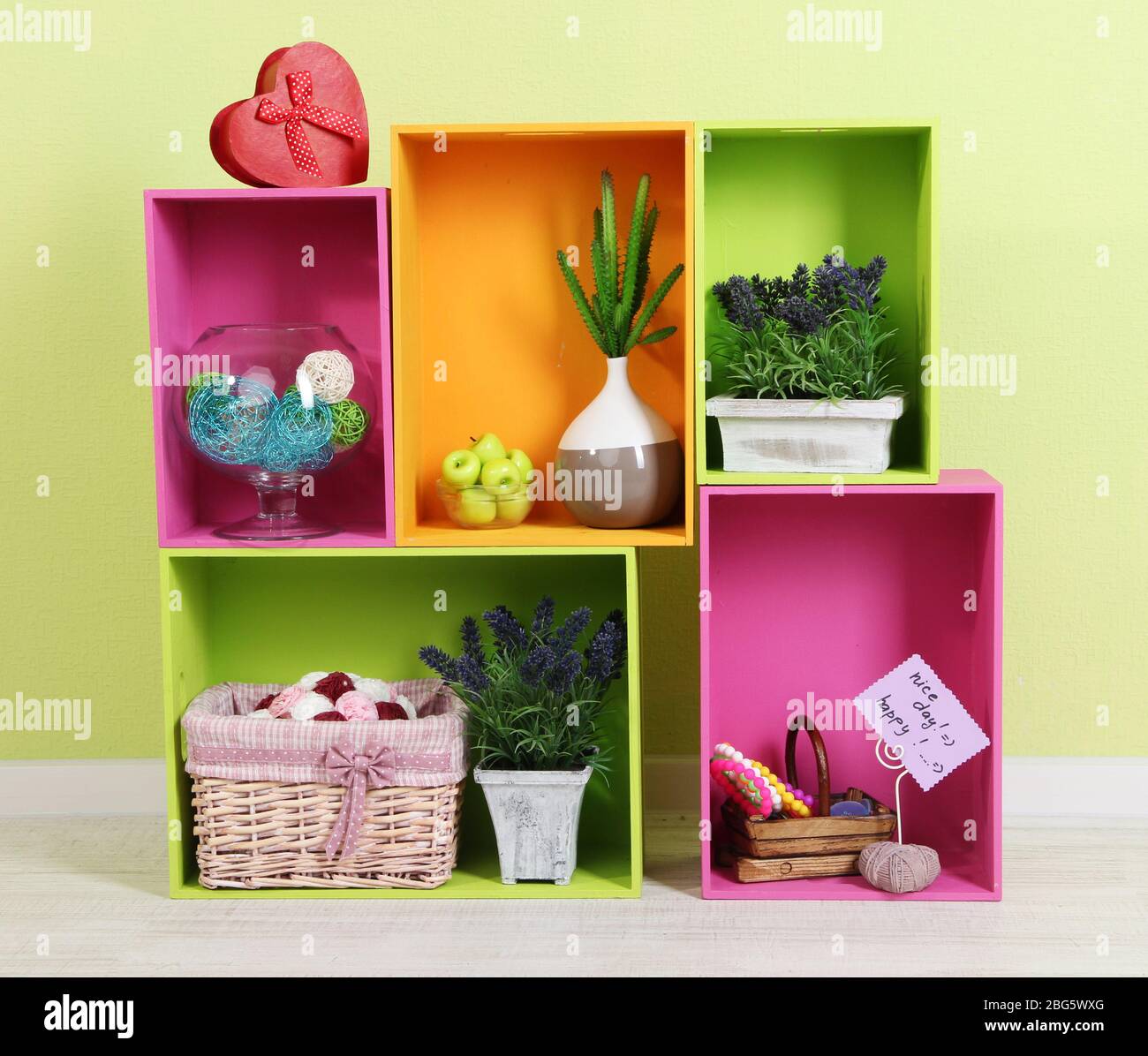 Shelves of different bright colors with decorative addition on wall ...