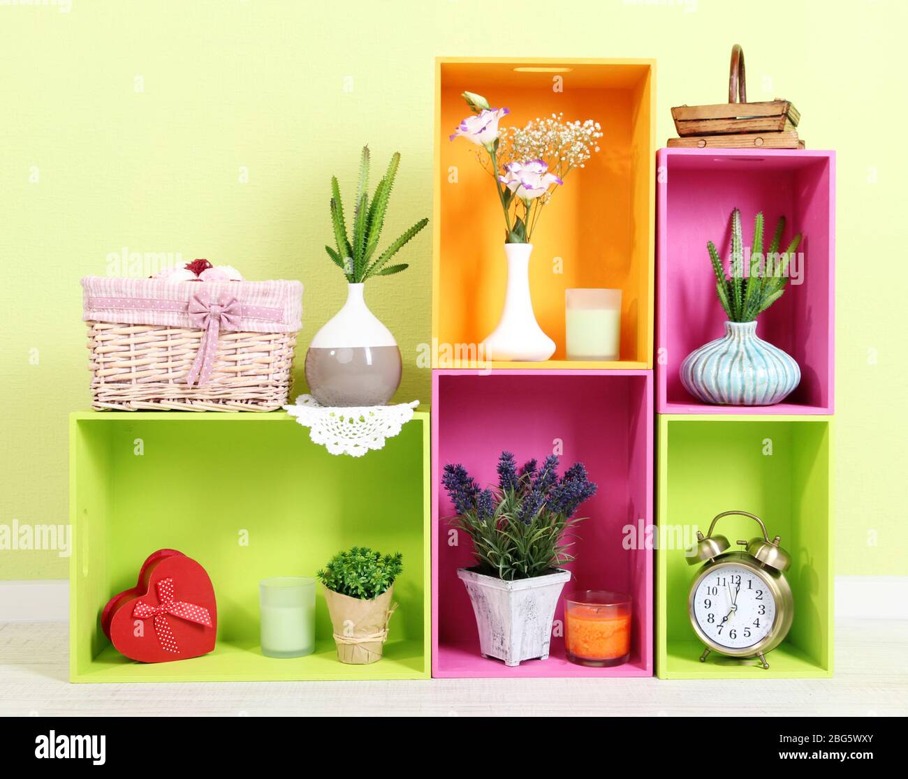 Shelves of different bright colors with decorative addition on wall ...